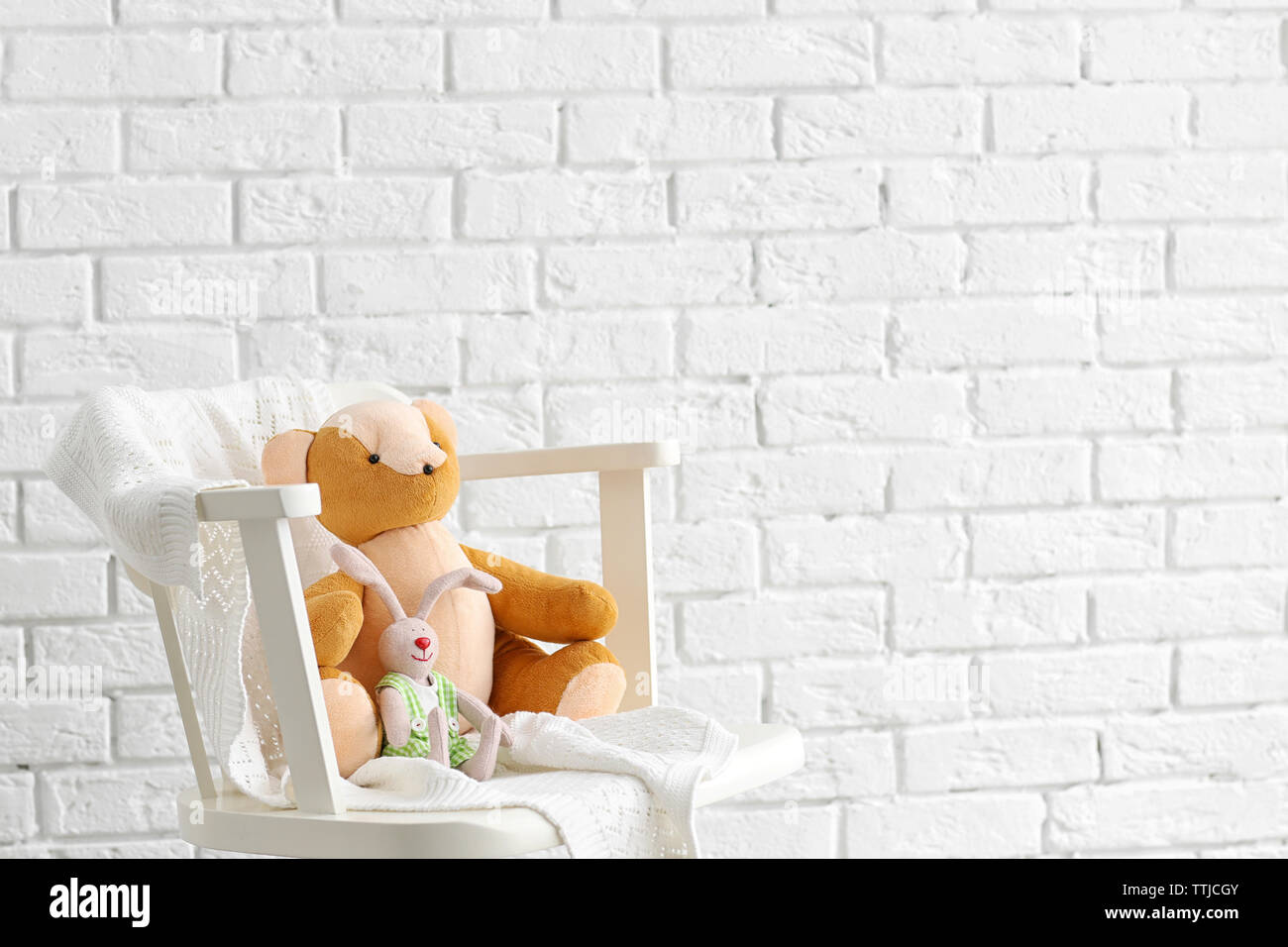 Baby toys on brick wall background Stock Photo - Alamy