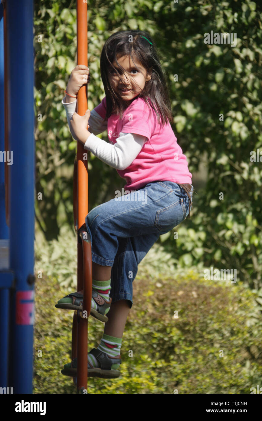Child playing climbing pole hi-res stock photography and images - Alamy