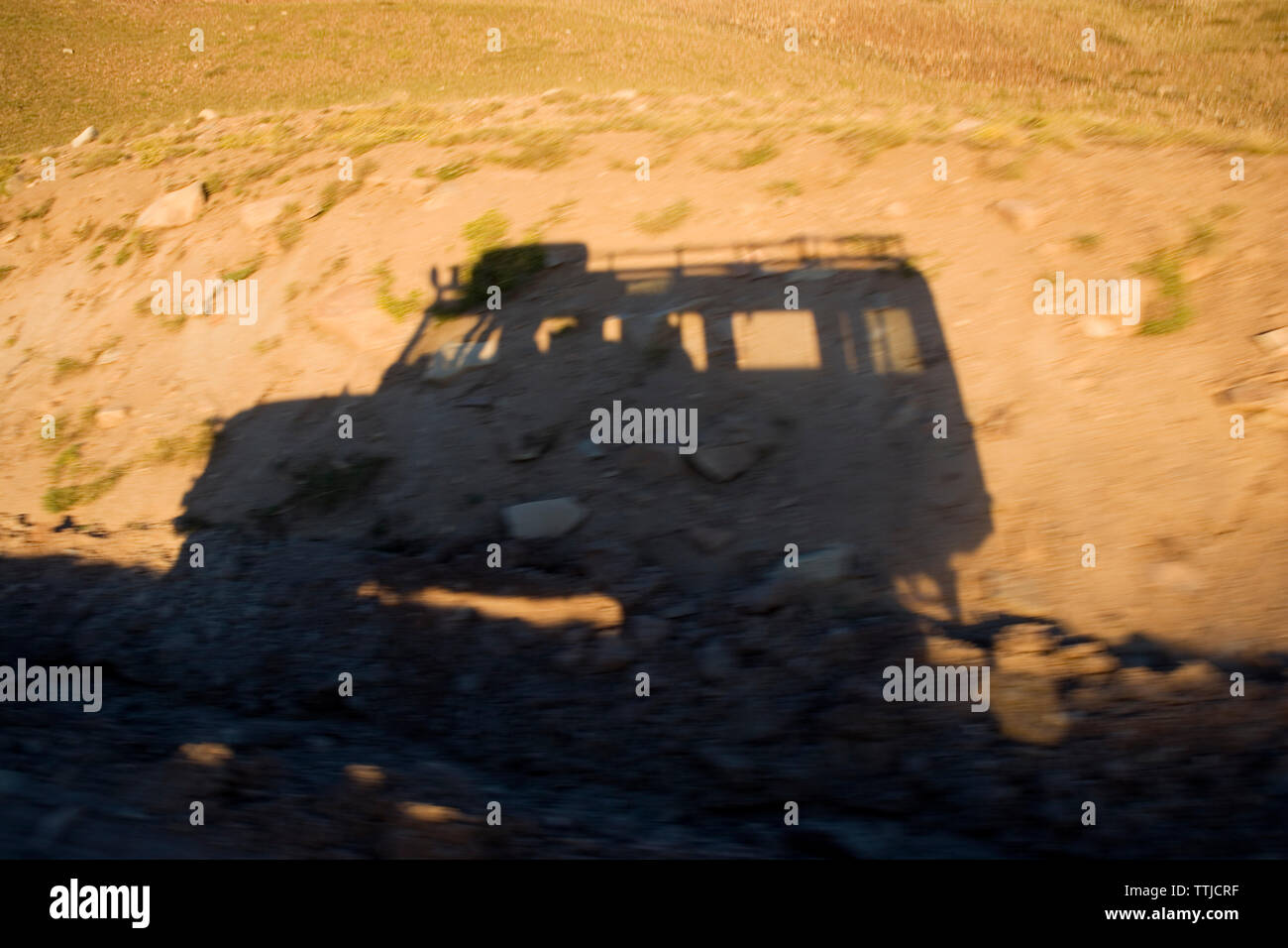 Shadow of off-road vehicle on field Stock Photo - Alamy