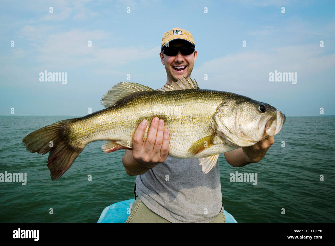 Portrait of man holding fish Stock Photo - Alamy
