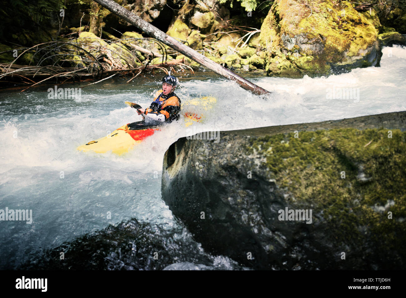 Man enjoying kayaking in river Stock Photo - Alamy