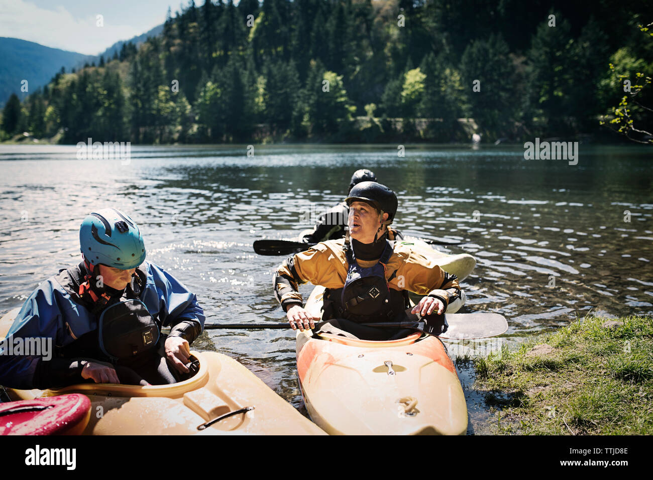 Friends sitting in kayak at river Stock Photo - Alamy
