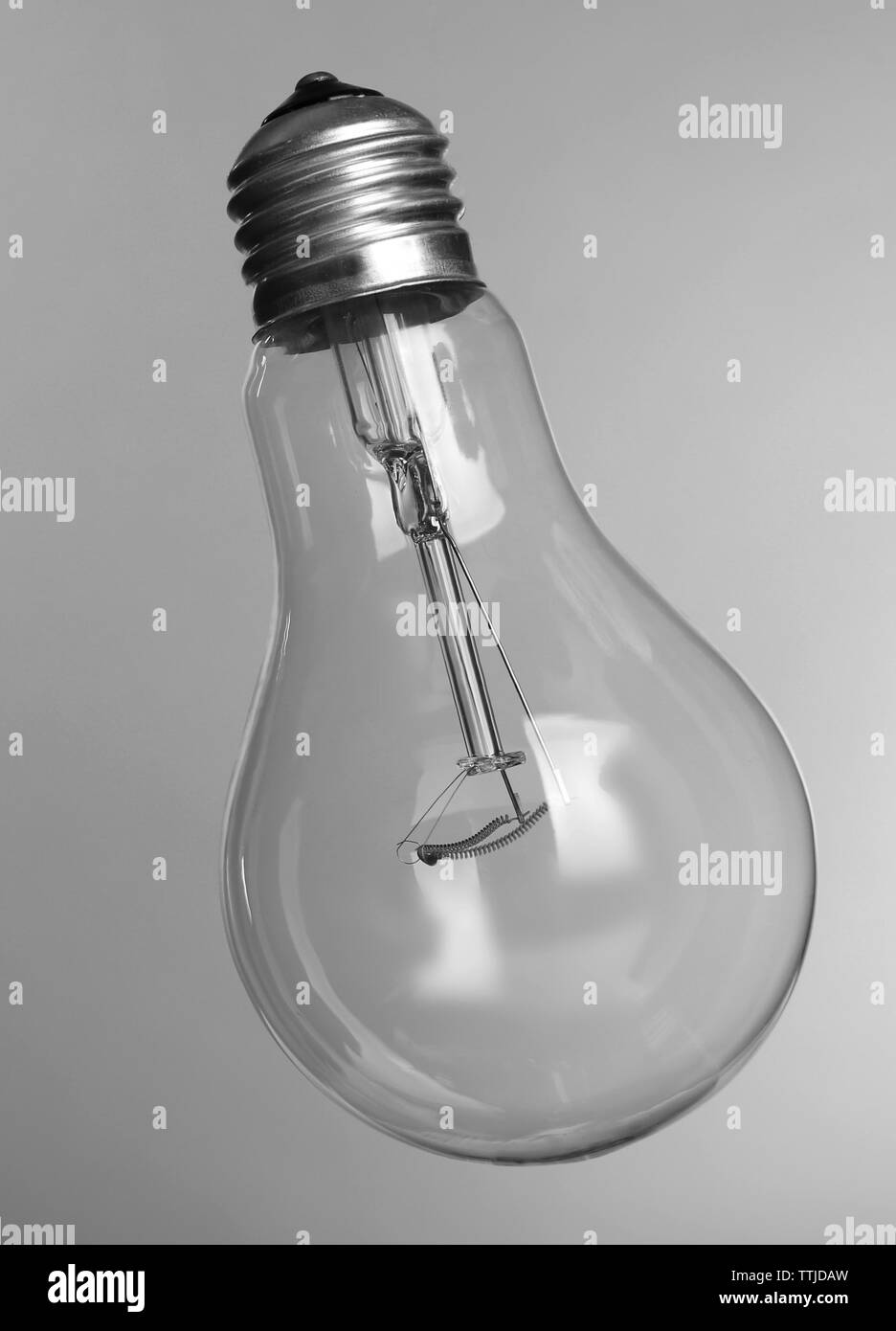 Light bulb on grey background Stock Photo - Alamy