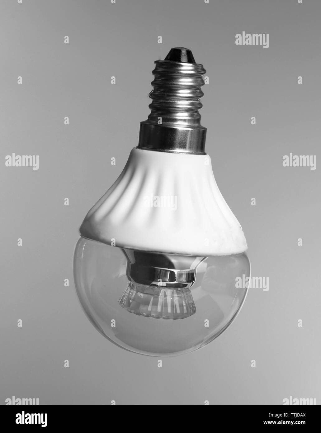 Light bulb on grey background Stock Photo - Alamy