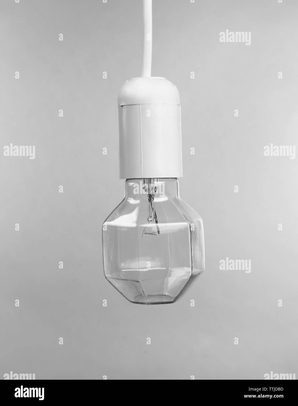 Light bulb on grey background Stock Photo - Alamy
