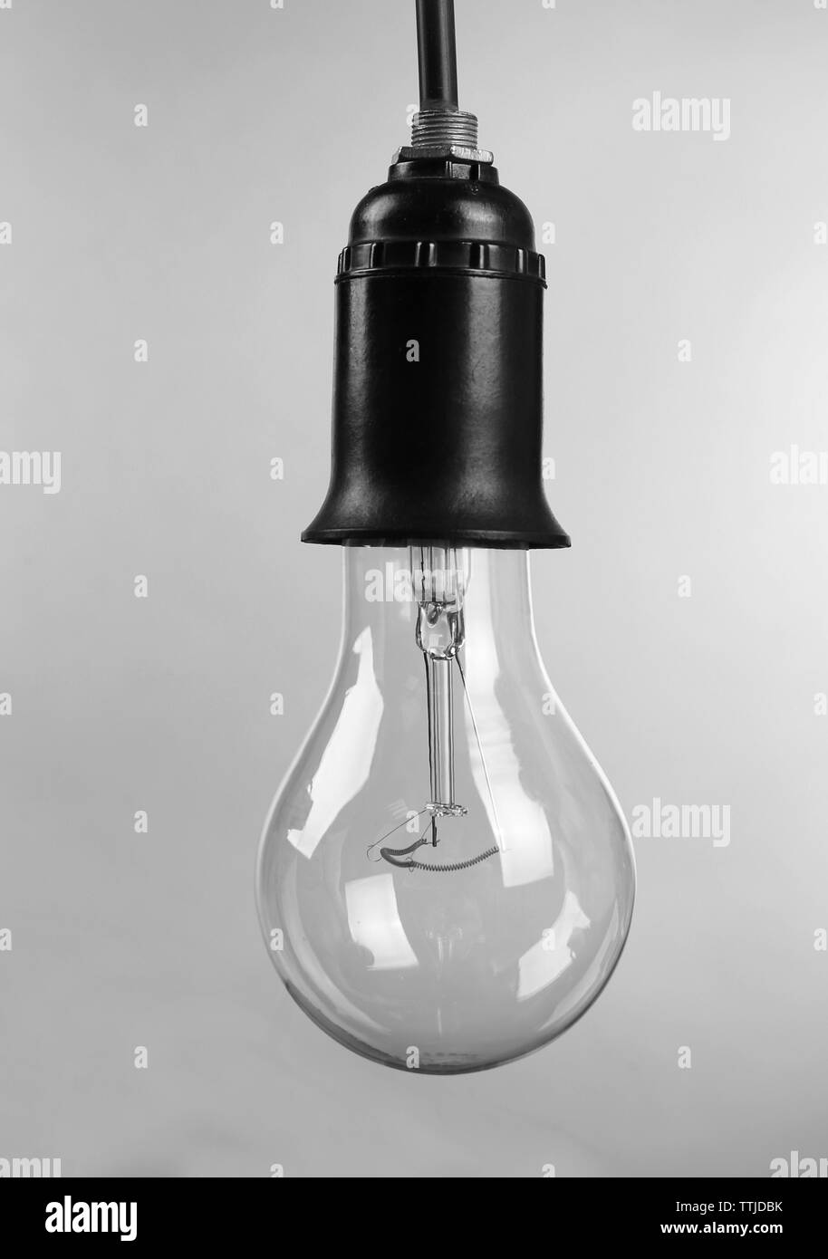Light bulb on grey background Stock Photo - Alamy