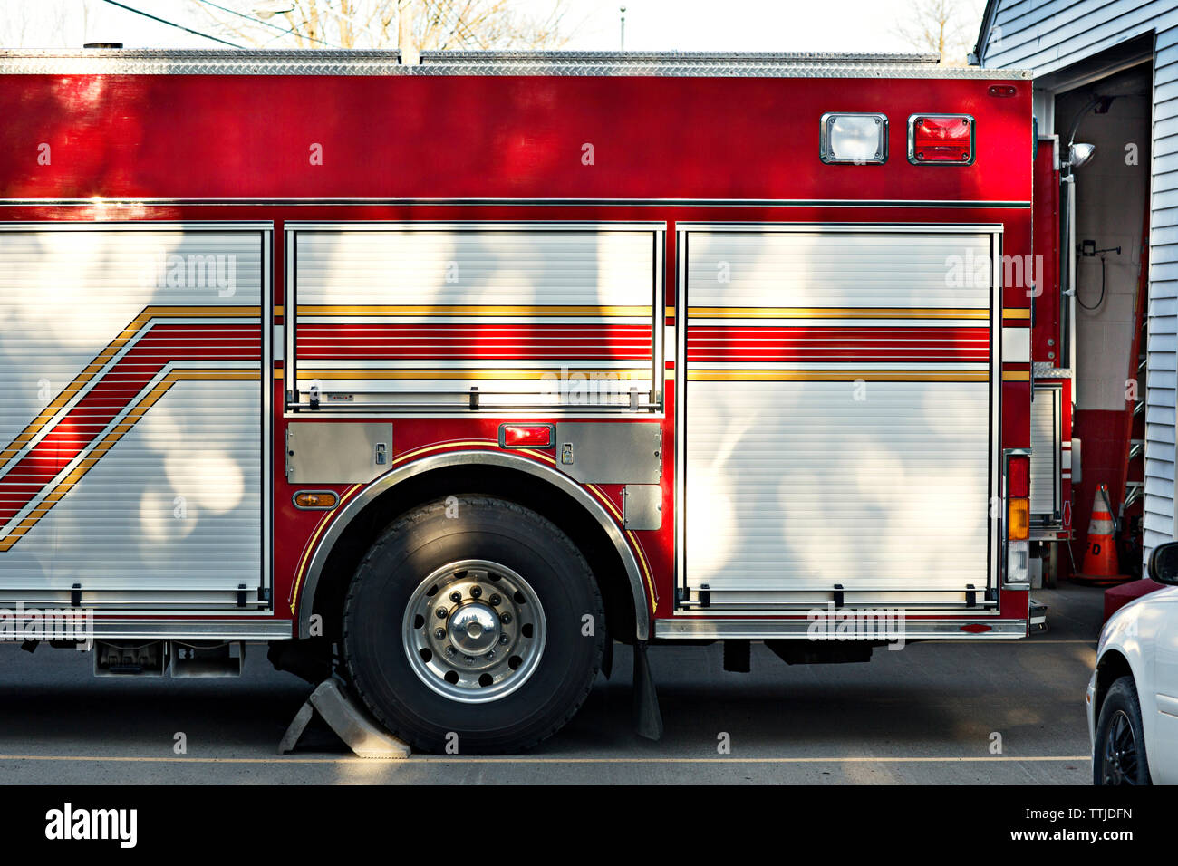 Cropped image of fire engine outside fire station Stock Photo - Alamy