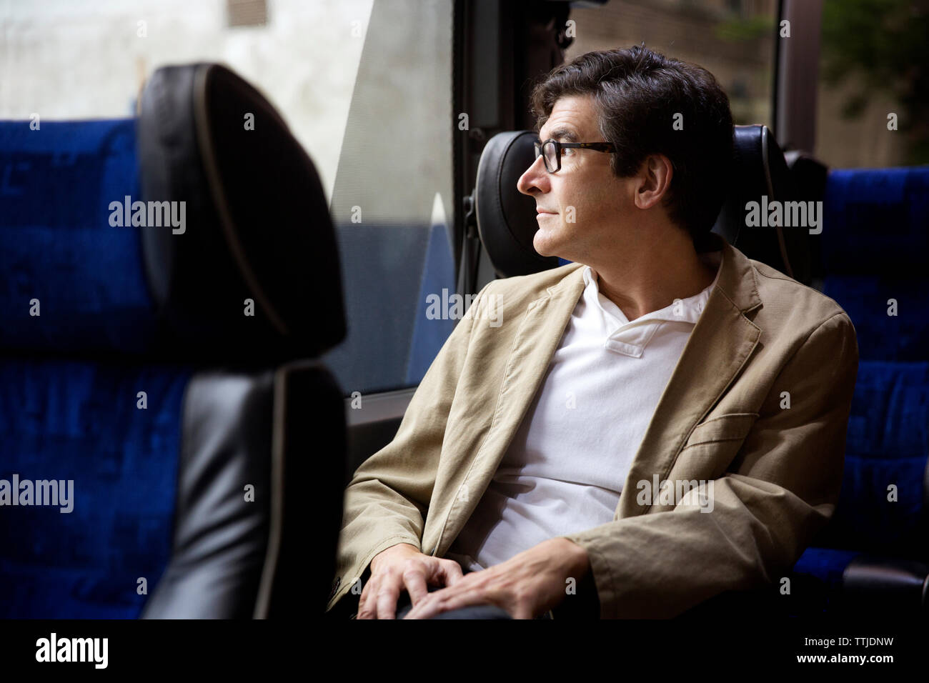 Man looking through bus window hi-res stock photography and images - Alamy