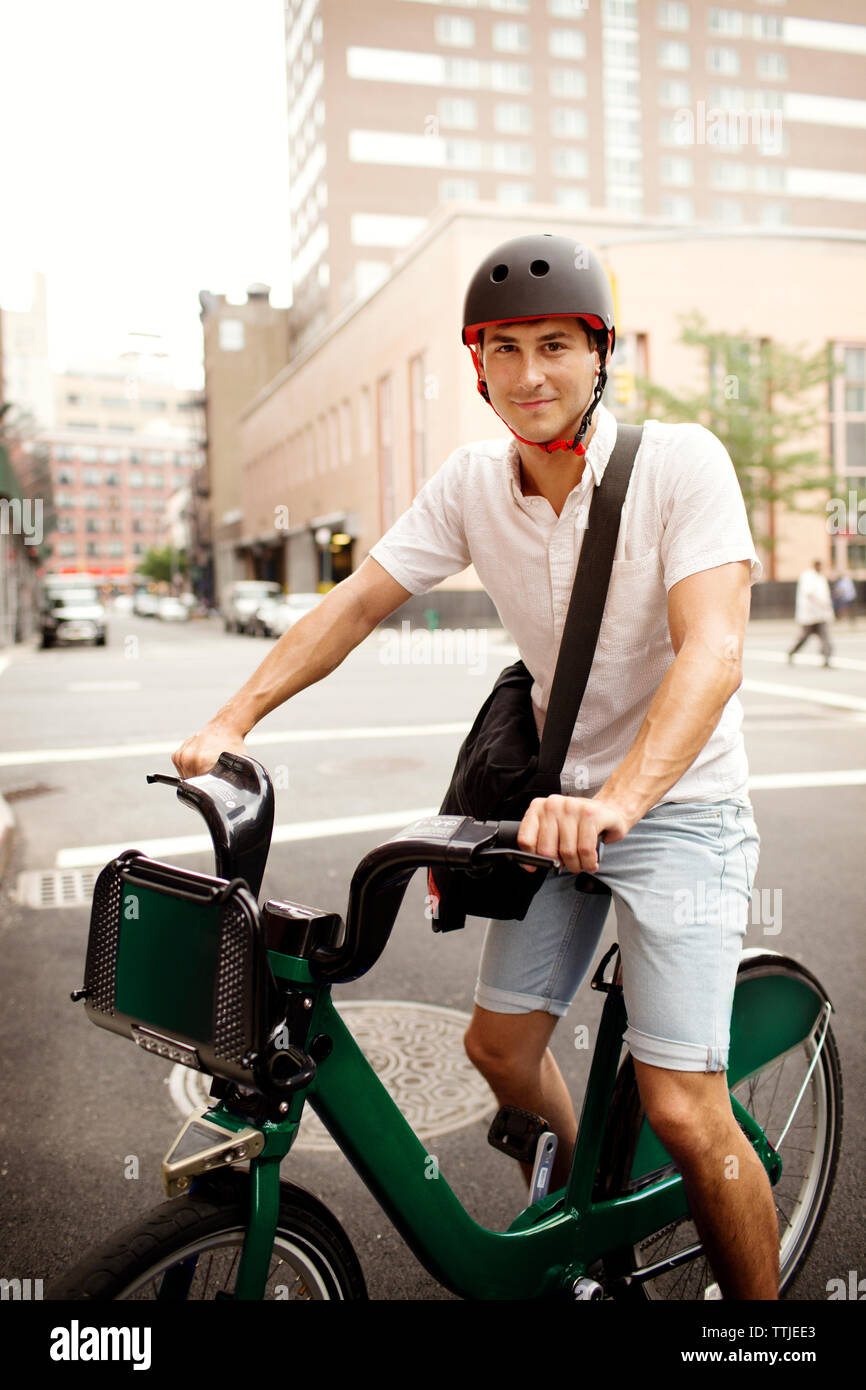 Smiling man standing bicycle hi-res stock photography and images - Alamy