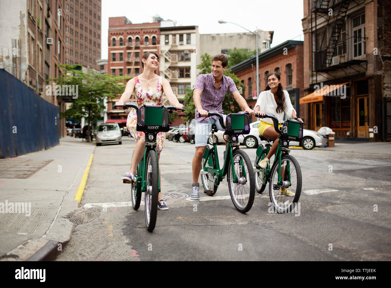 Young day sitting bicycle friends women hi-res stock photography and ...