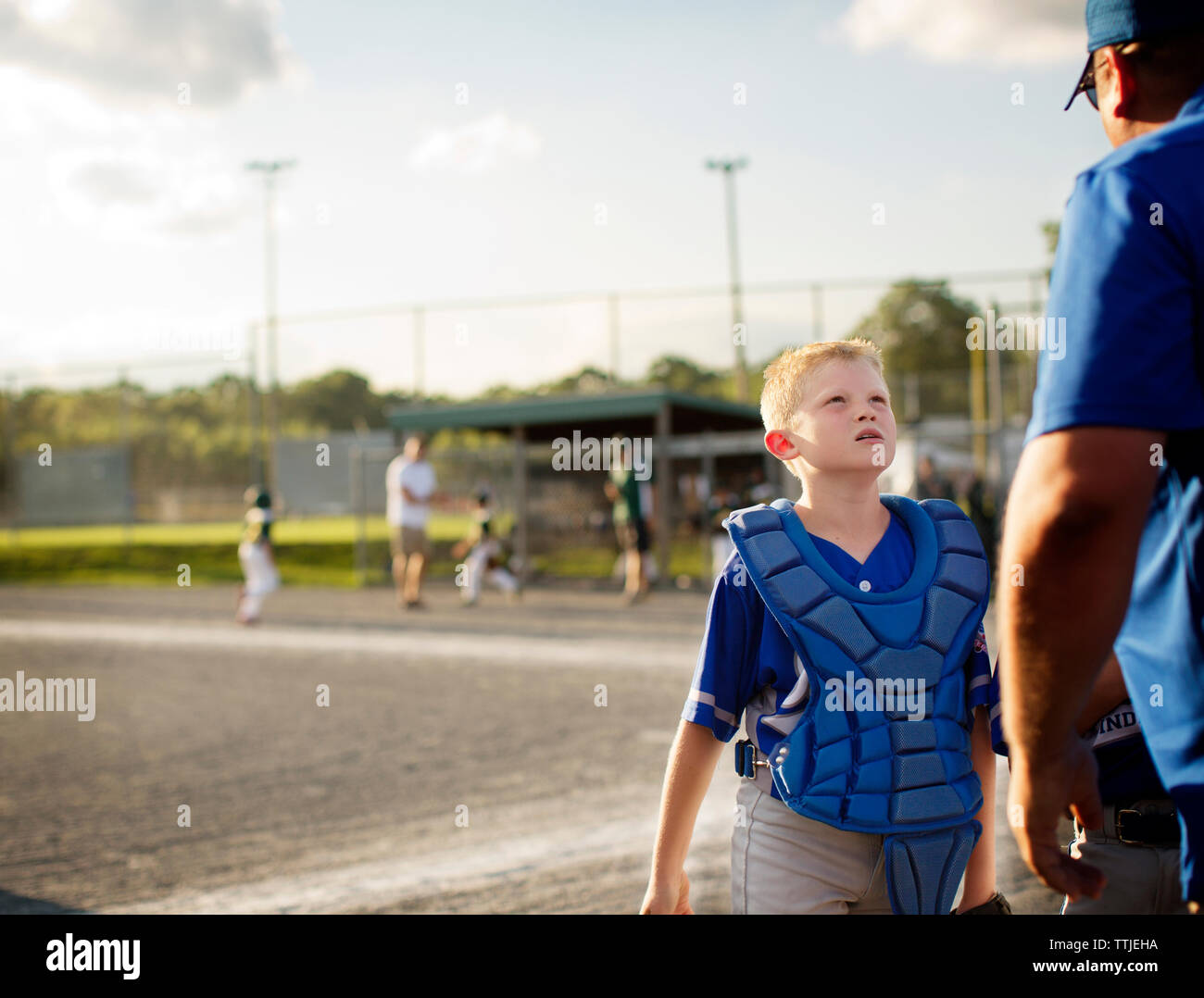 Coach guiding to player on field Stock Photo - Alamy