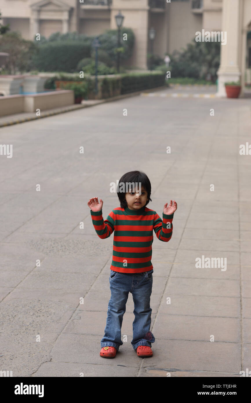 Girl standing with arms raised Stock Photo - Alamy