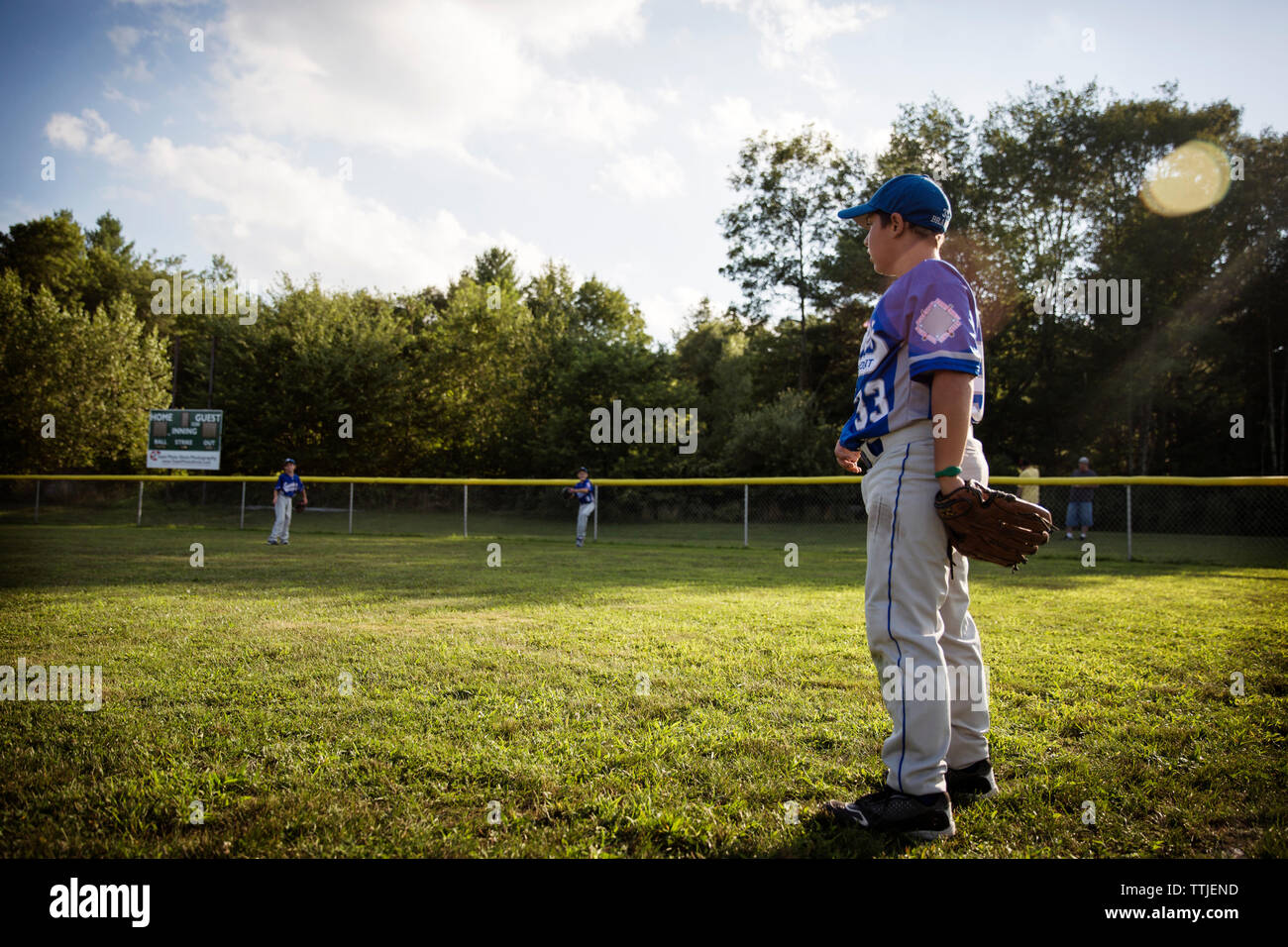 Side view of boy playing baseball on field Stock Photo - Alamy