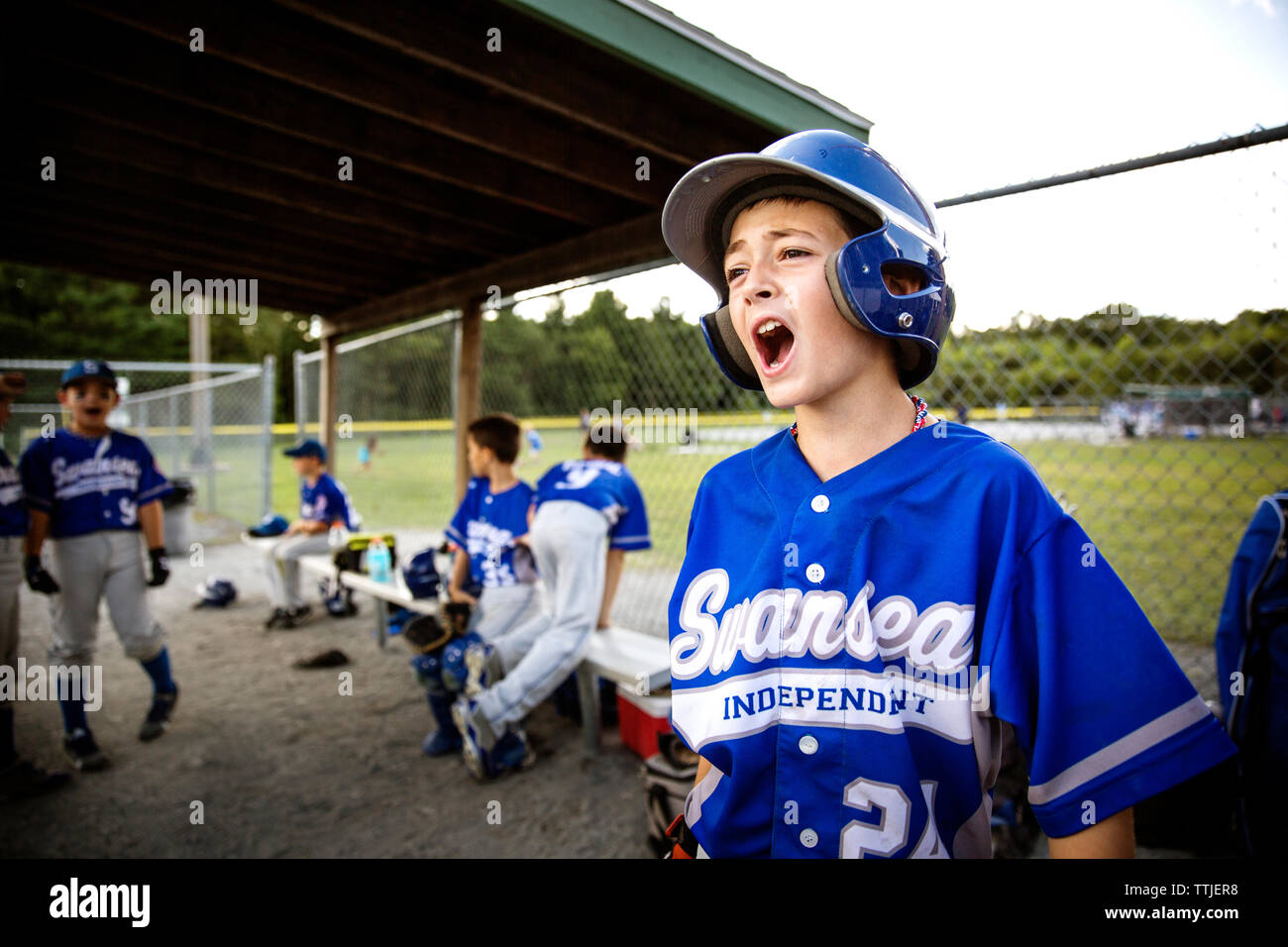Baseball player shouting while standing in dugout Stock Photo - Alamy