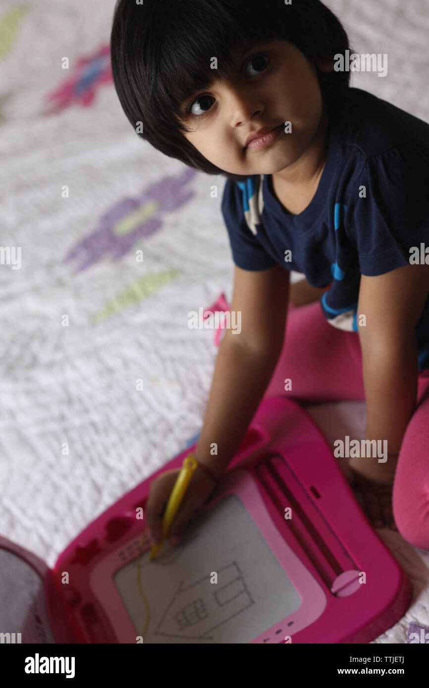 Girl drawing on a magna doodle Stock Photo - Alamy