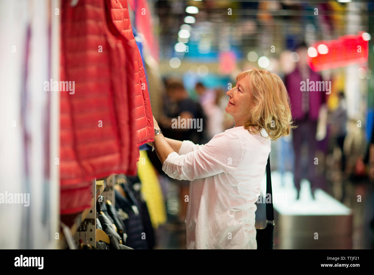 Side view of woman shopping in store Stock Photo - Alamy