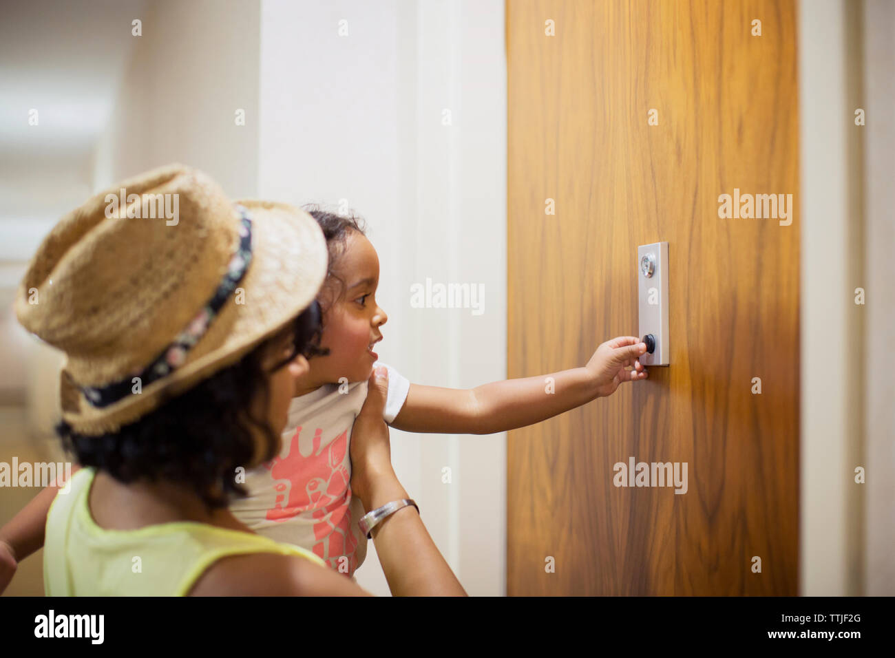 Woman pushing elevator button hi-res stock photography and images - Alamy