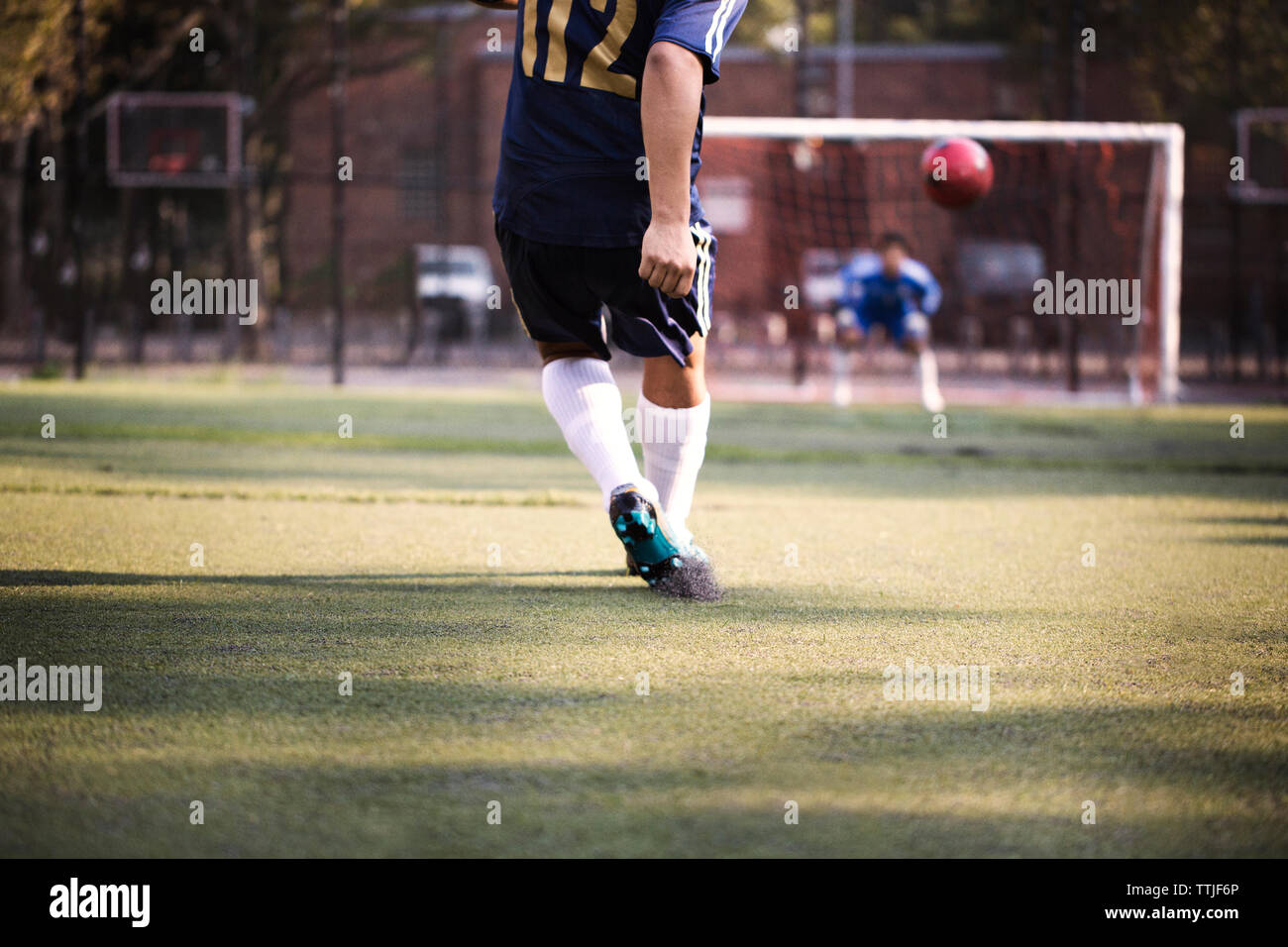 Man kicking ball hi-res stock photography and images - Alamy