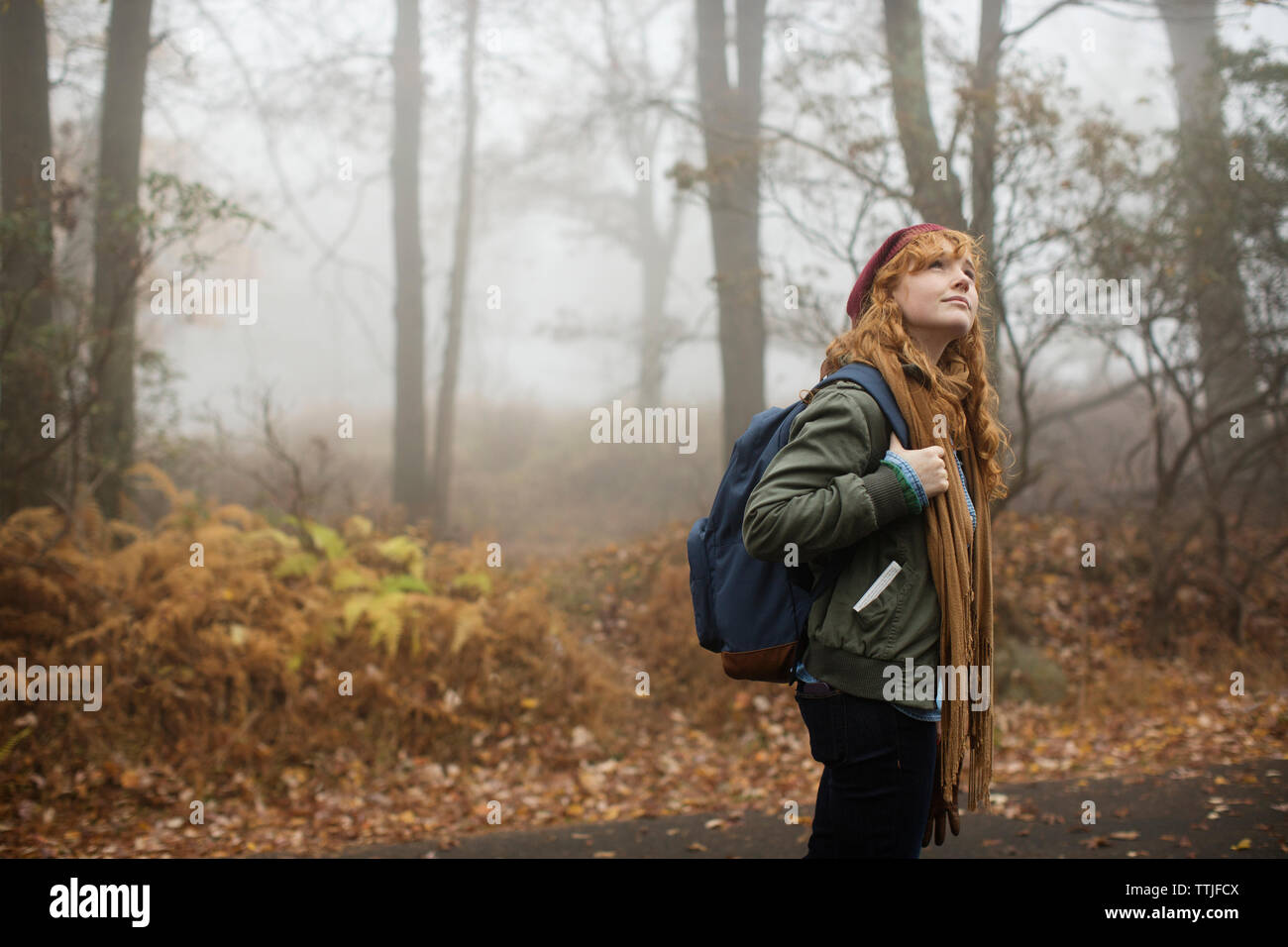 Woman holding her backpack hi-res stock photography and images - Alamy