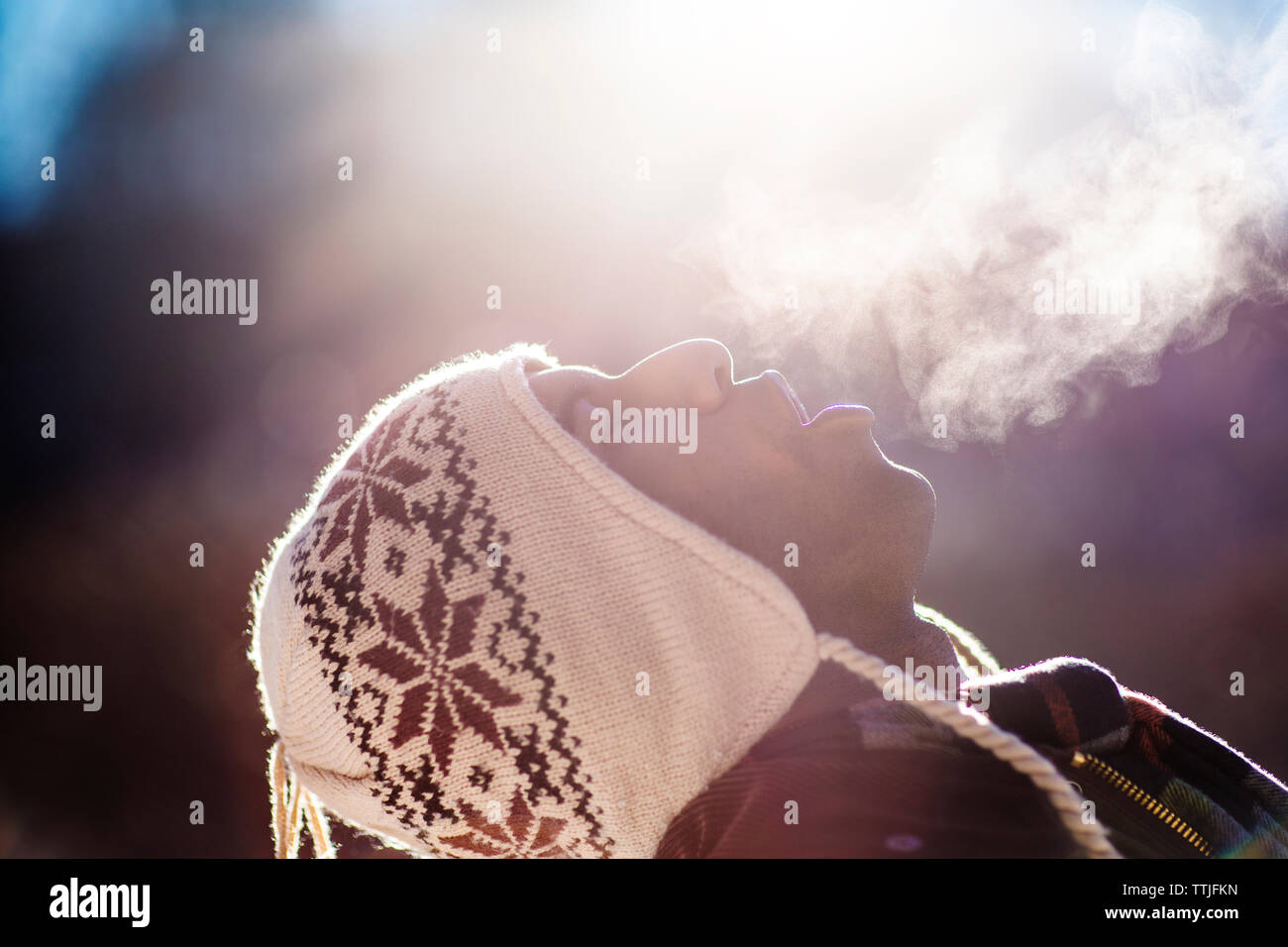 Side view of man blowing smoke Stock Photo - Alamy