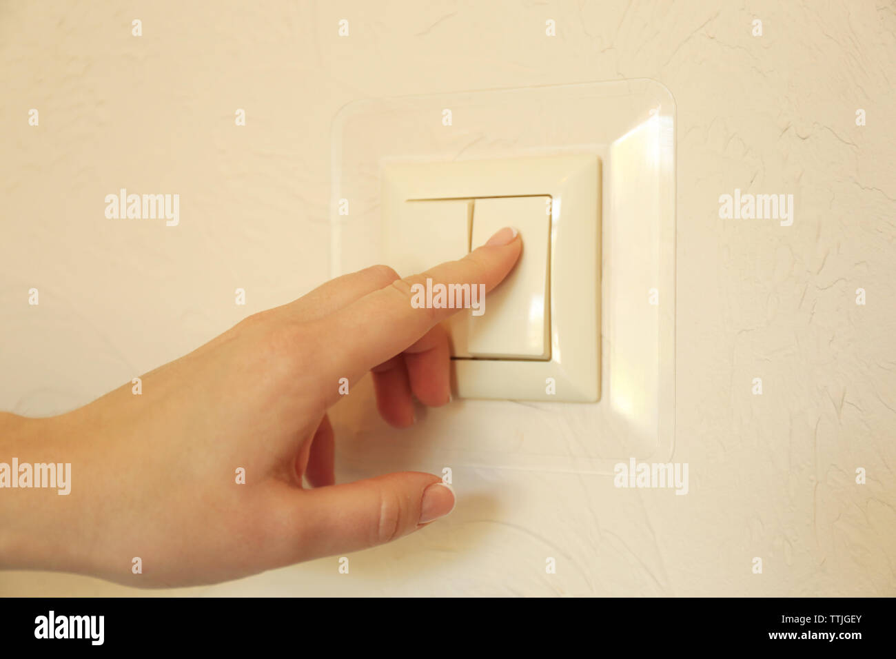 A finger is turning on a light switch Stock Photo - Alamy