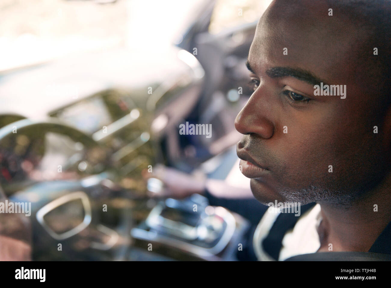 Man looking away while driving car Stock Photo - Alamy