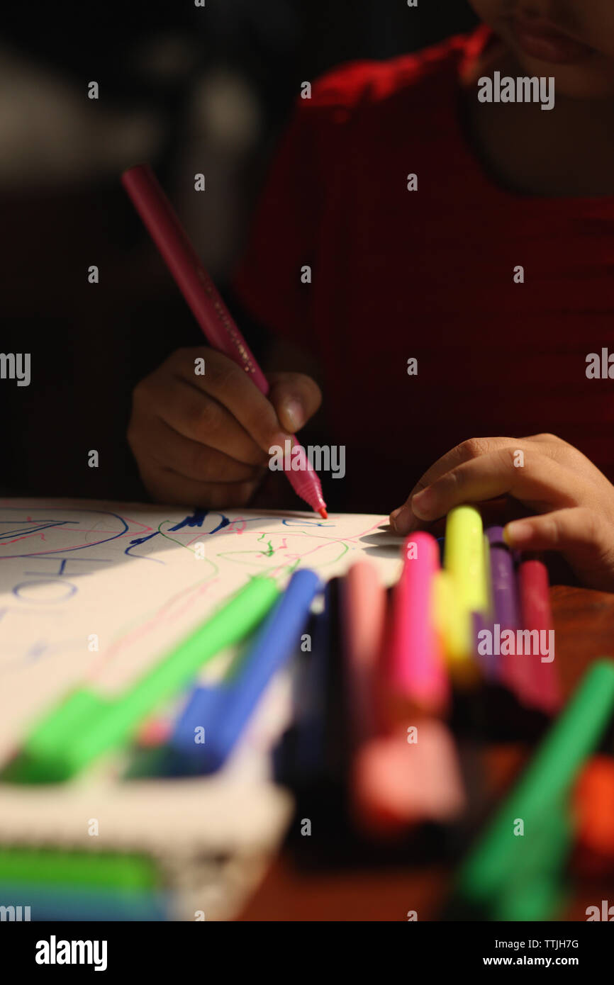 Girl drawing with colored pencil on a drawing board Stock Photo - Alamy
