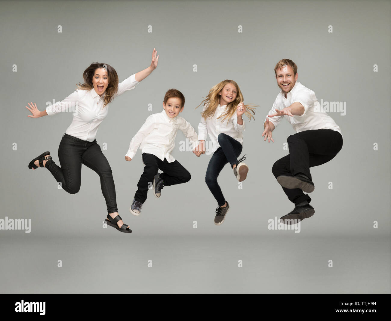 Portrait Playful Siblings Jumping High Resolution Stock Photography and ...