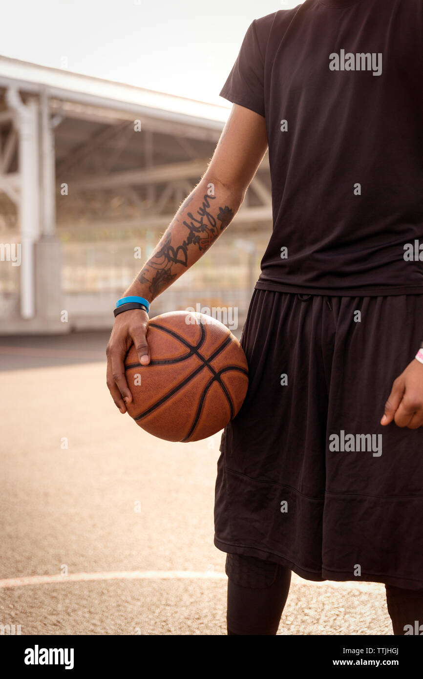 Young man holding basketball court hi-res stock photography and images ...