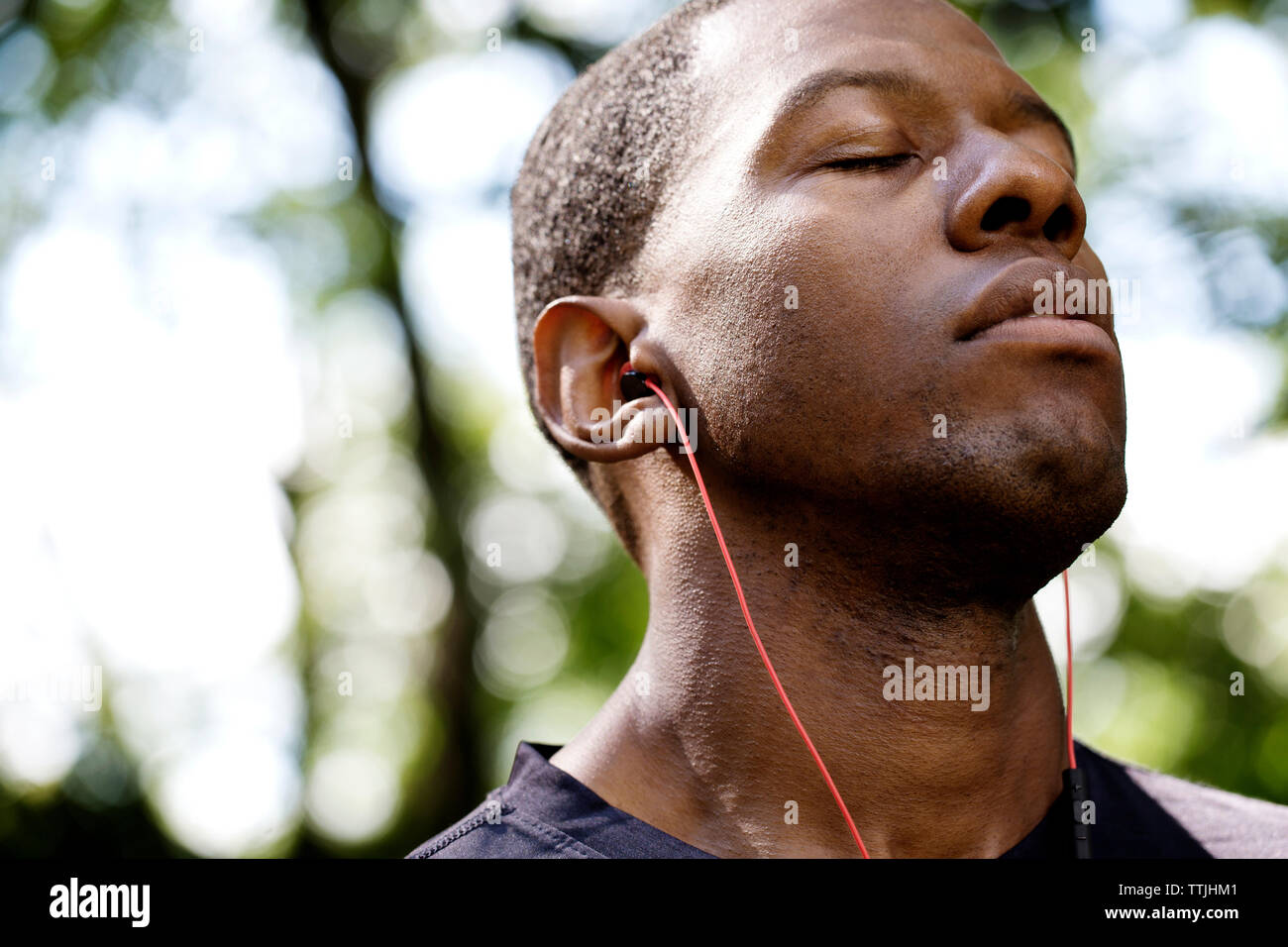 Close-up of man with eyes closed listening music Stock Photo - Alamy