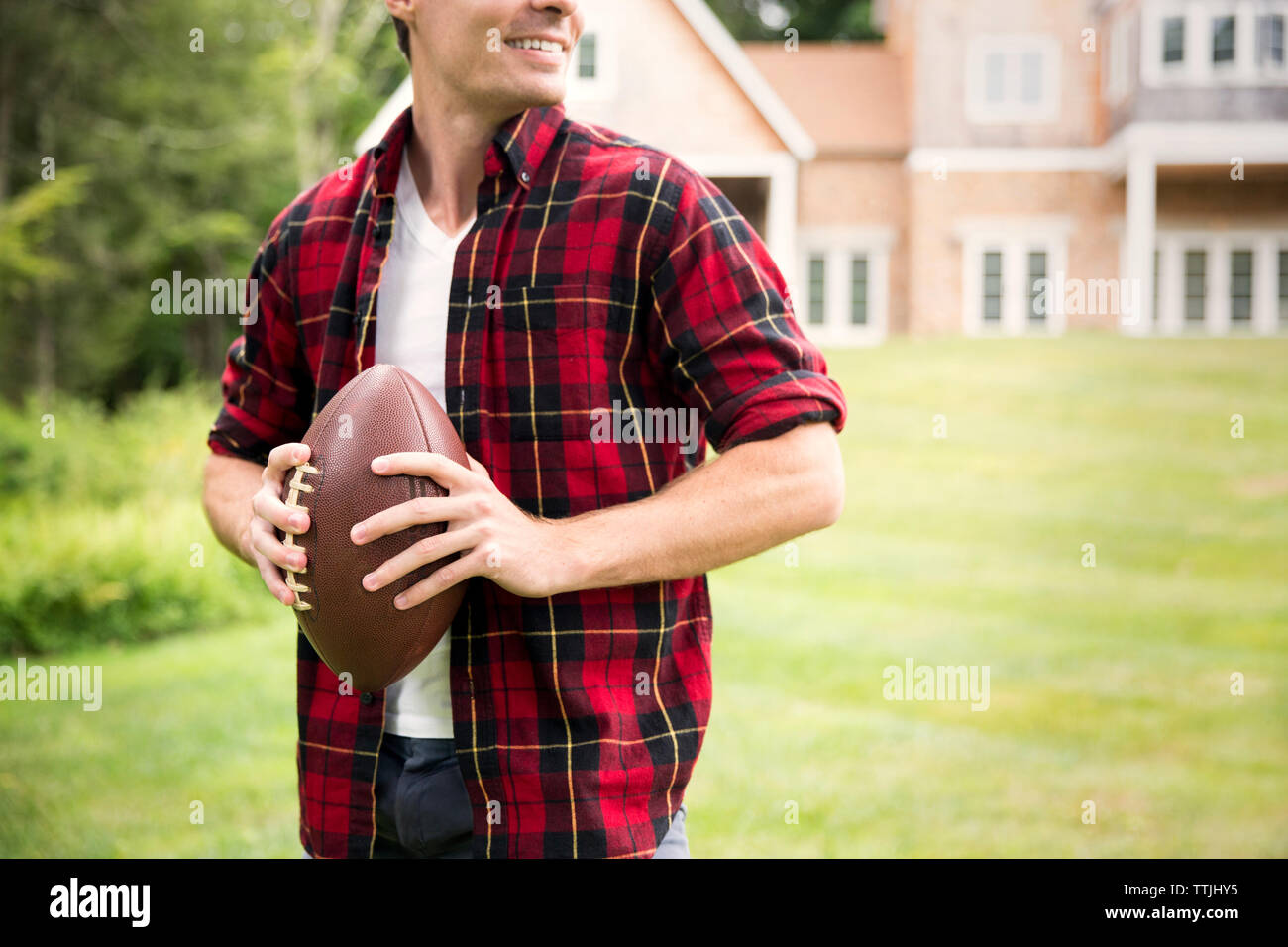 Man holding football smiling hi-res stock photography and images - Alamy