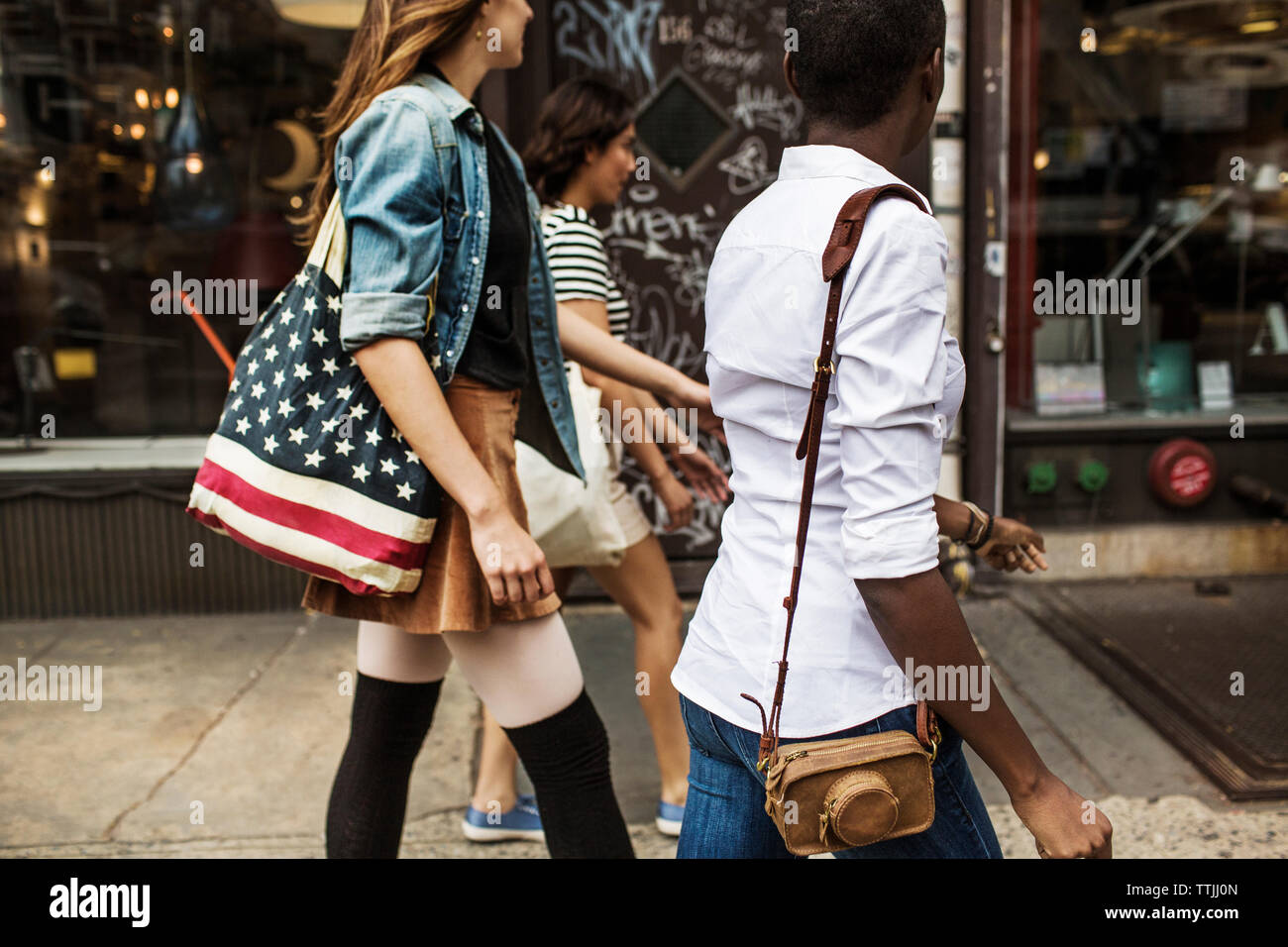 Three friends walking in the street hi-res stock photography and images ...