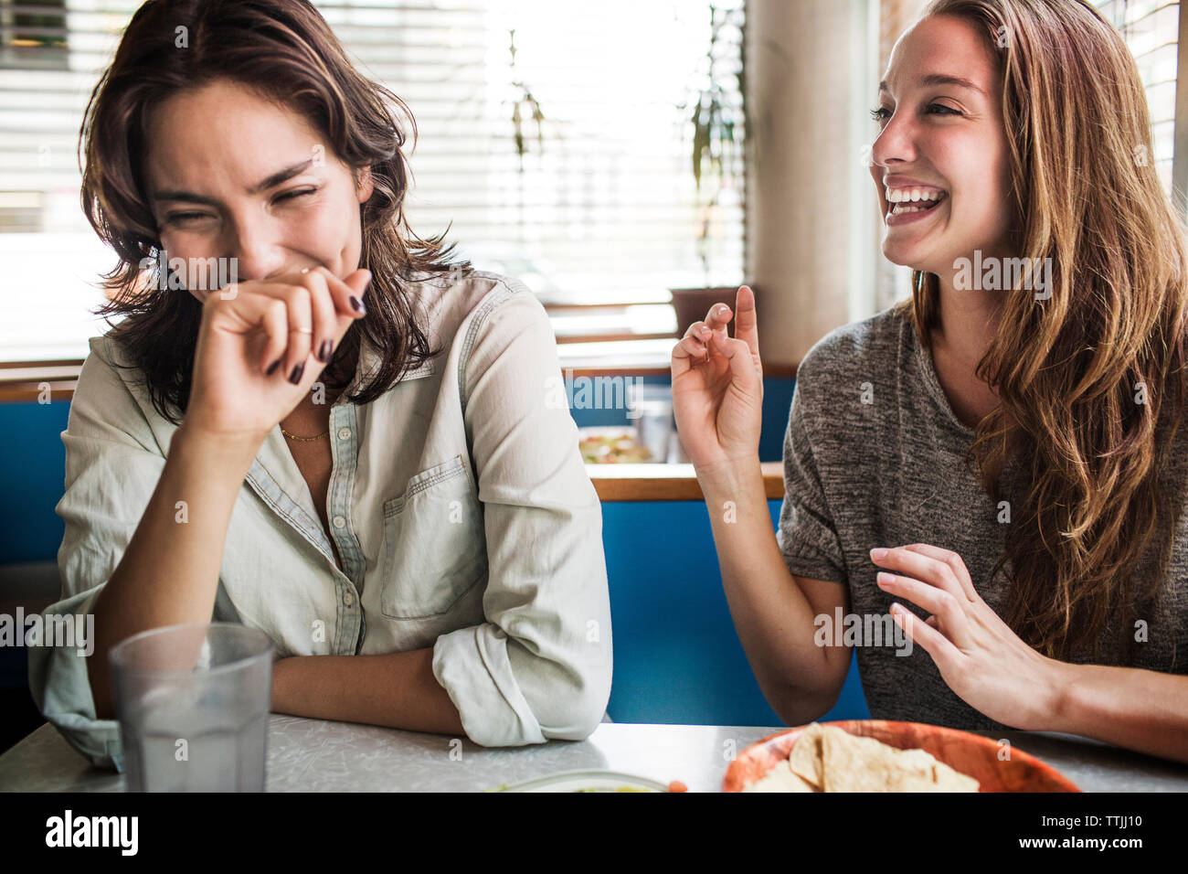 Women laughing restaurant table hi-res stock photography and images - Alamy