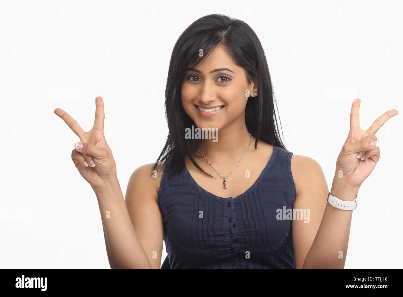 Portrait of a woman showing v sign Stock Photo - Alamy