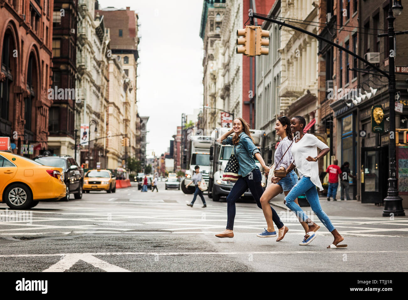 Holding hands crossing road hi-res stock photography and images - Alamy