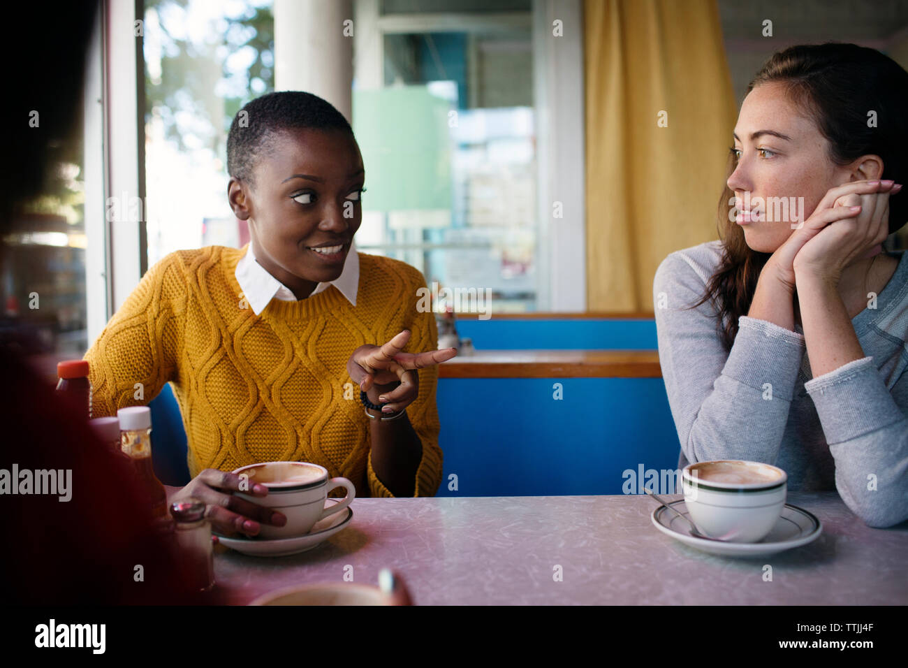 Women in cafe holding cups hi-res stock photography and images - Alamy