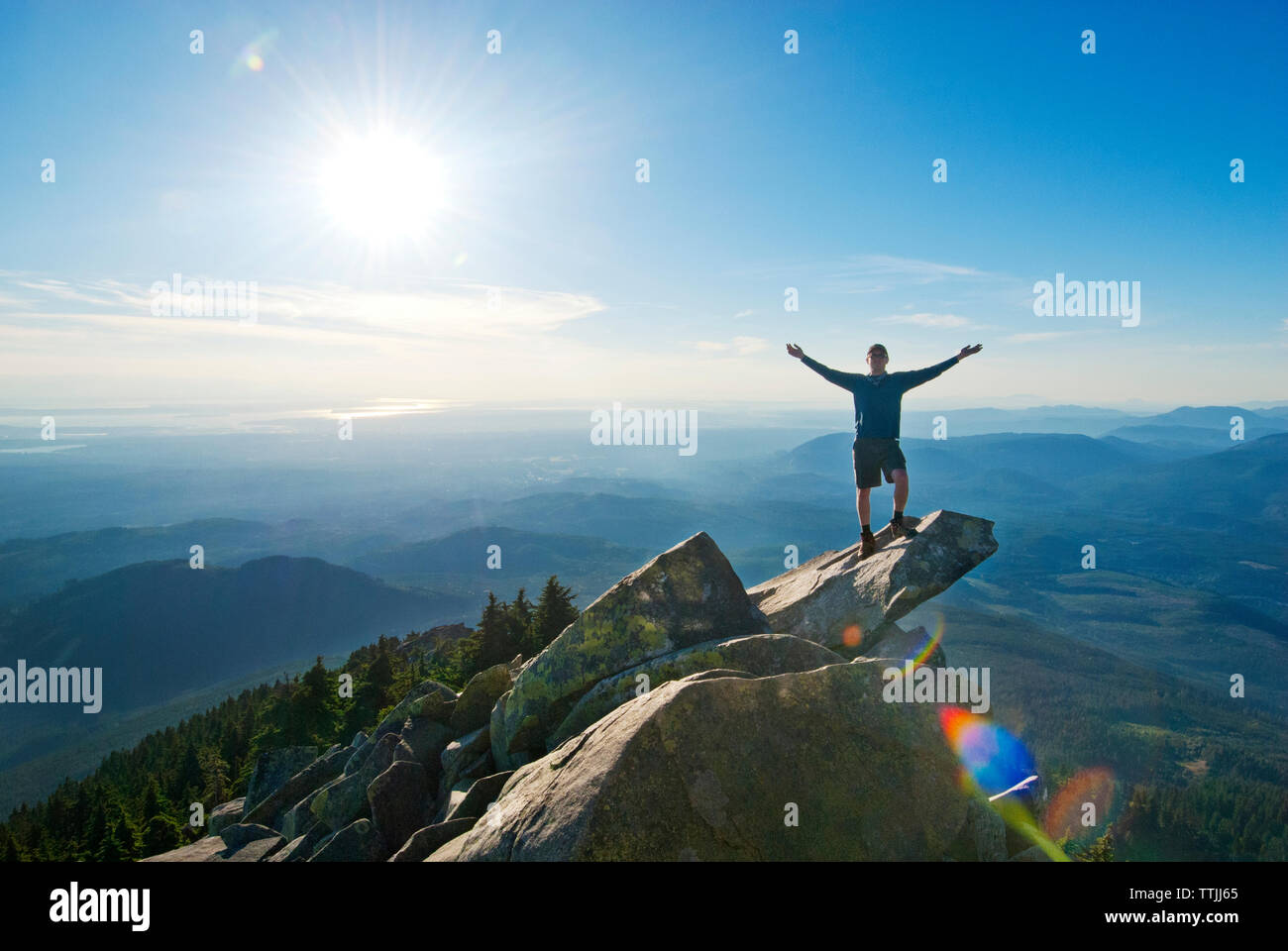 Man standing on mountain against sky Stock Photo - Alamy