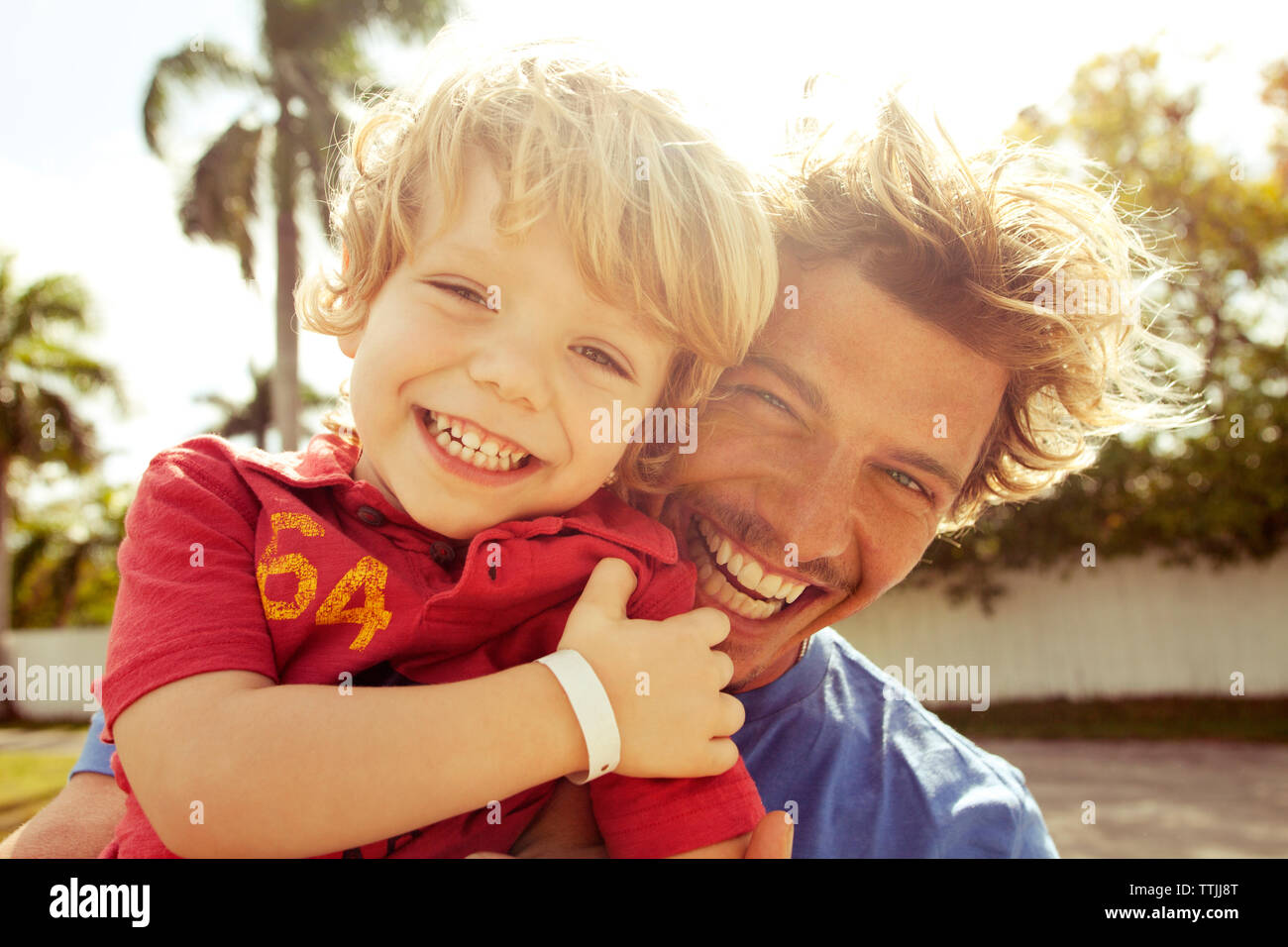 Portrait of father and son standing at backyard Stock Photo - Alamy