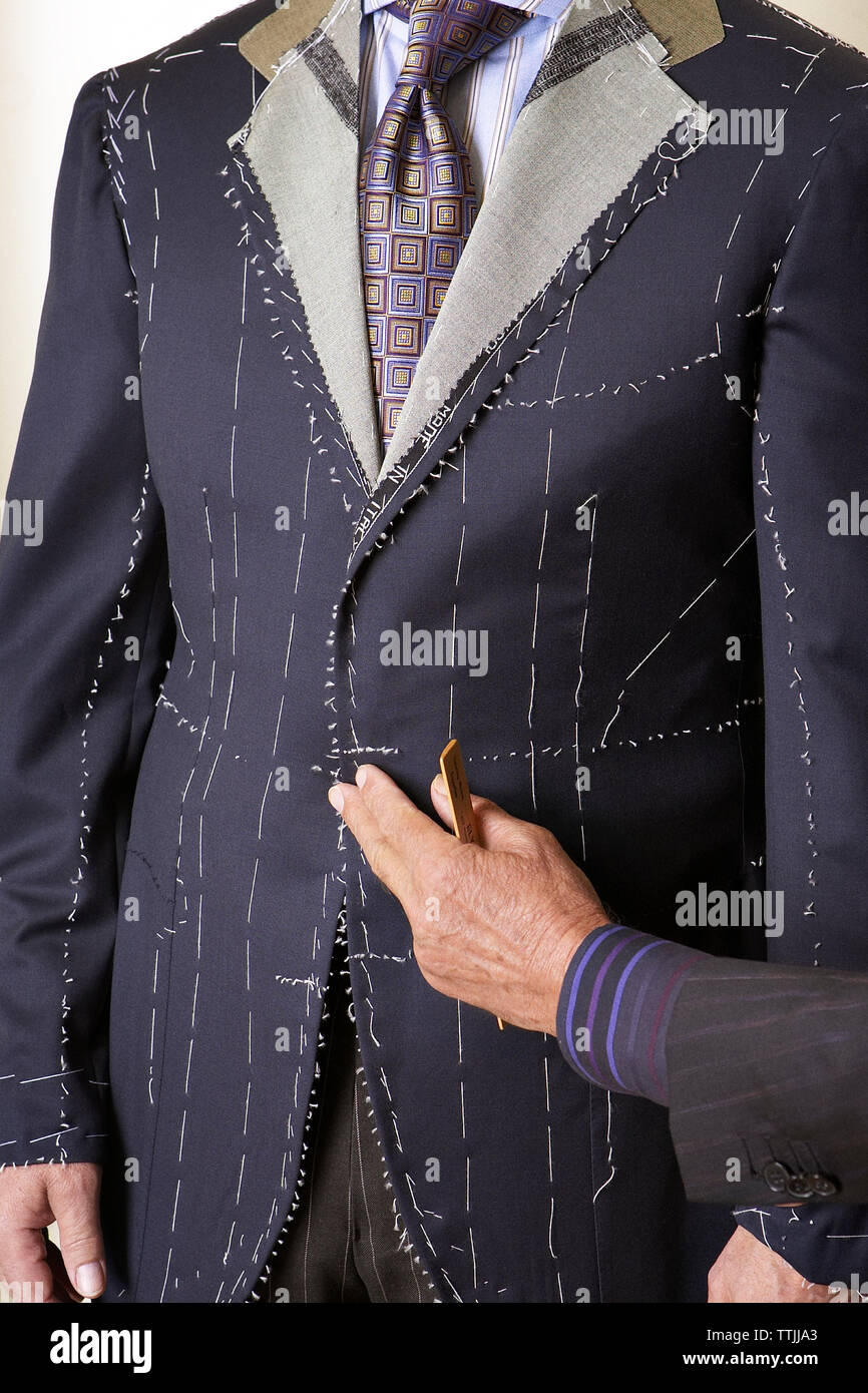 Cropped image of man designing suit Stock Photo - Alamy