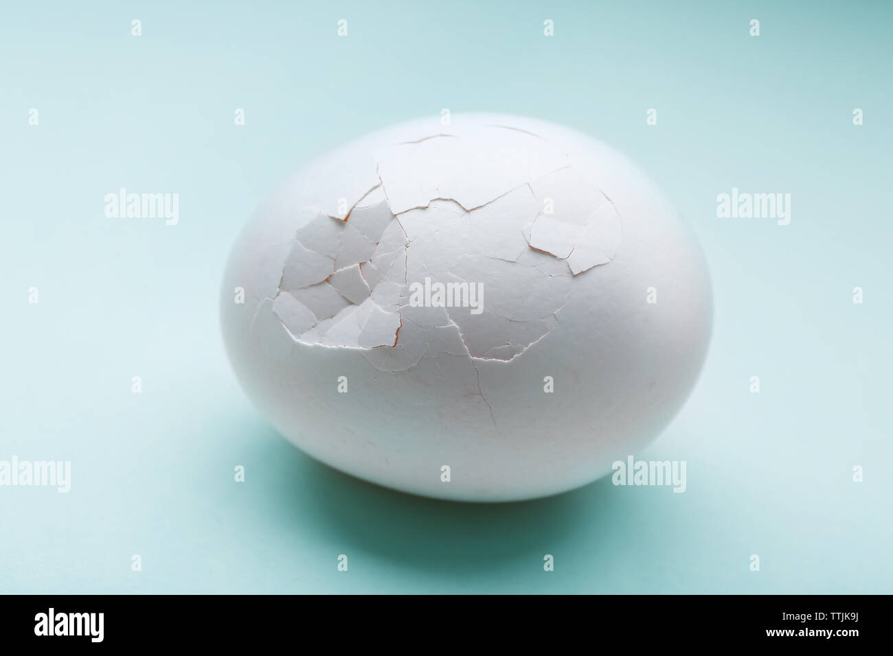 Cracked egg on white background Stock Photo - Alamy