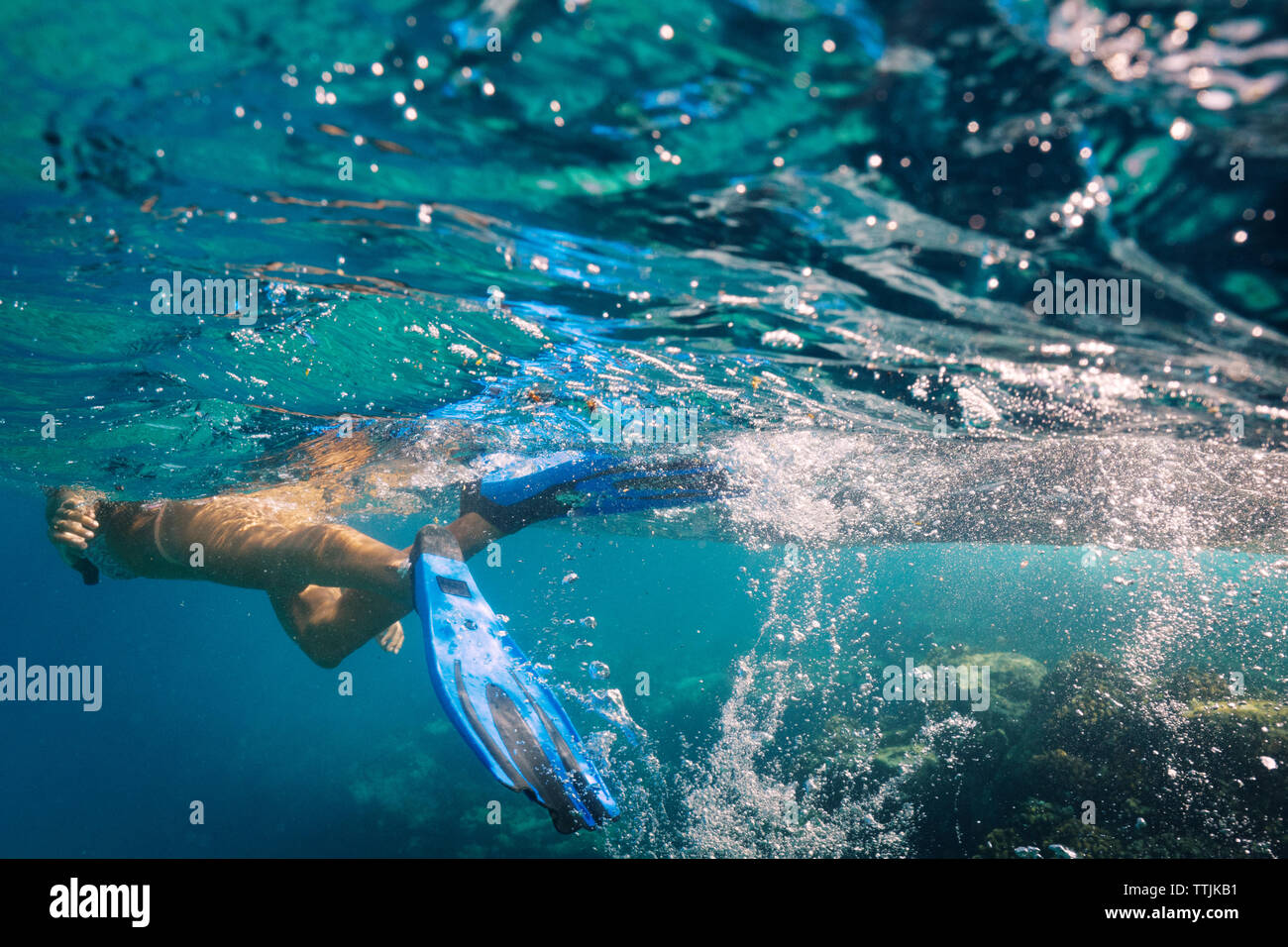Woman with diving fins swimming undersea Stock Photo - Alamy