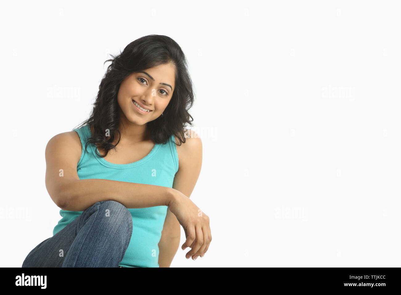 Portrait of a woman sitting and smiling Stock Photo - Alamy