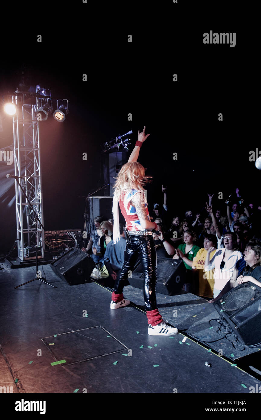 Rear view of rock musician standing on stage at concert Stock Photo - Alamy