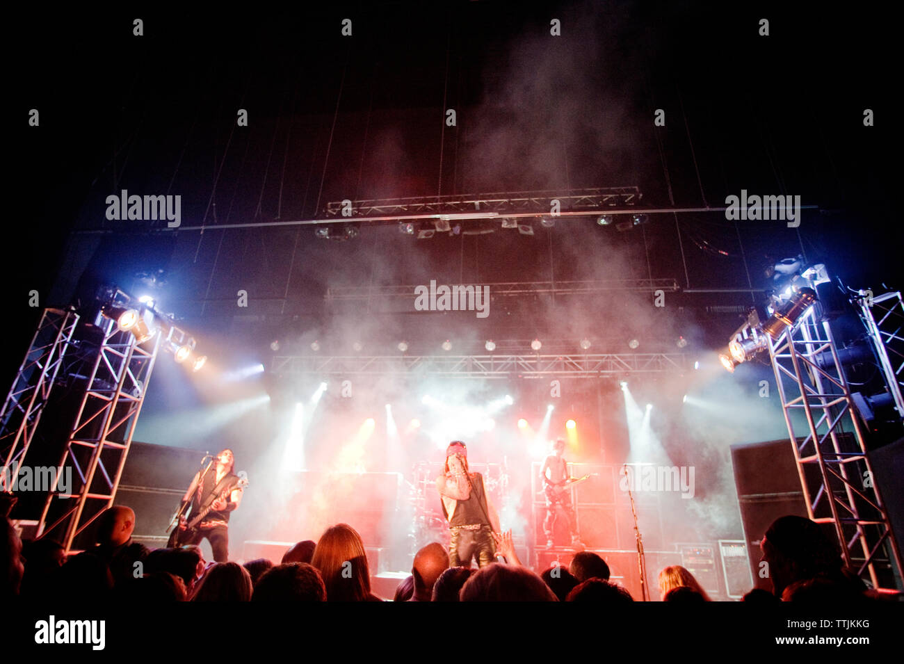 Rock band performing on stage at night Stock Photo - Alamy