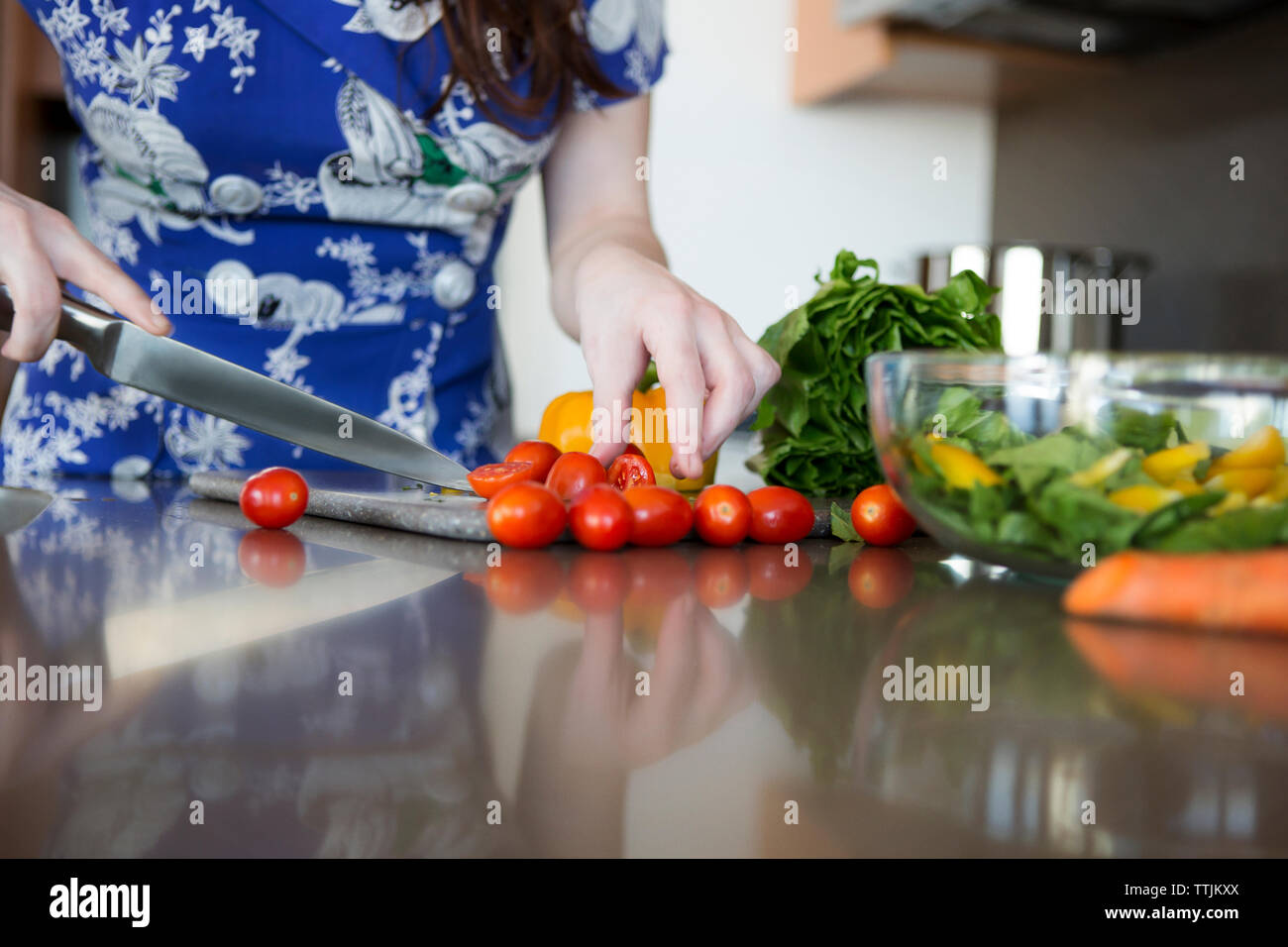 Midsection of woman cutting cherry tomatoes Stock Photo - Alamy