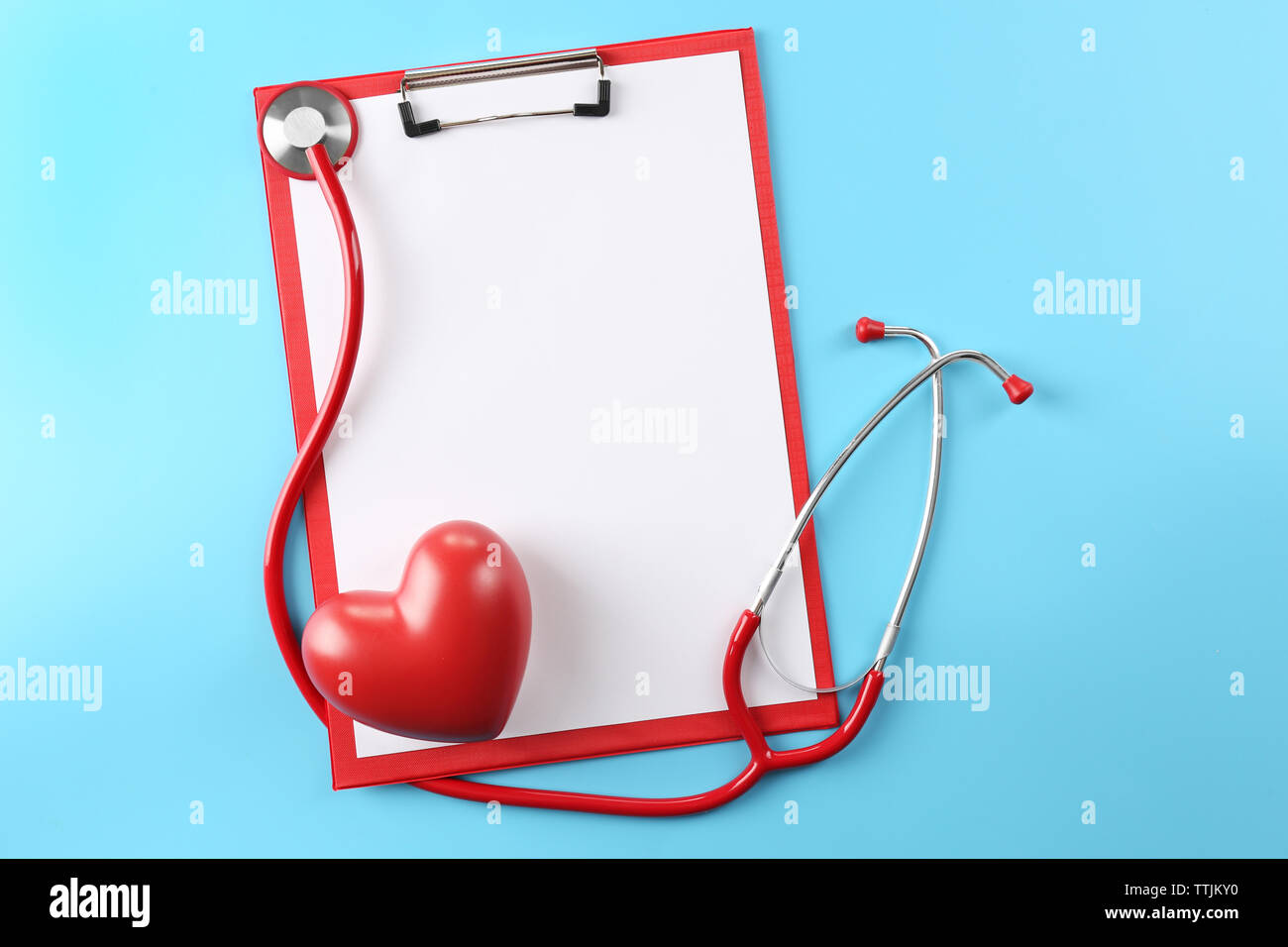 Red stethoscope with prescription on blue background Stock Photo - Alamy