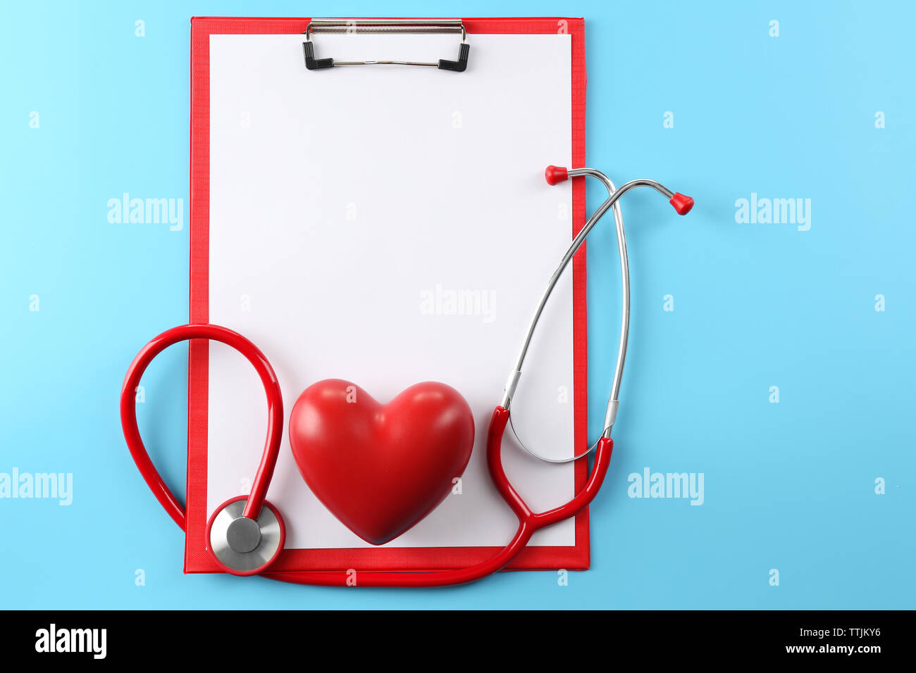 Red stethoscope with prescription on blue background Stock Photo - Alamy