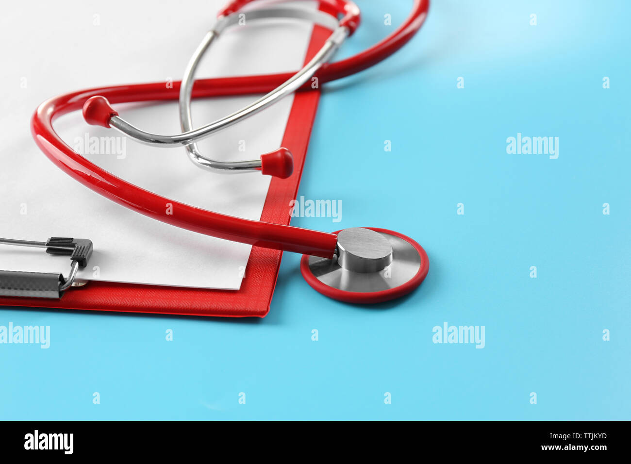 Red stethoscope with prescription on blue background Stock Photo - Alamy
