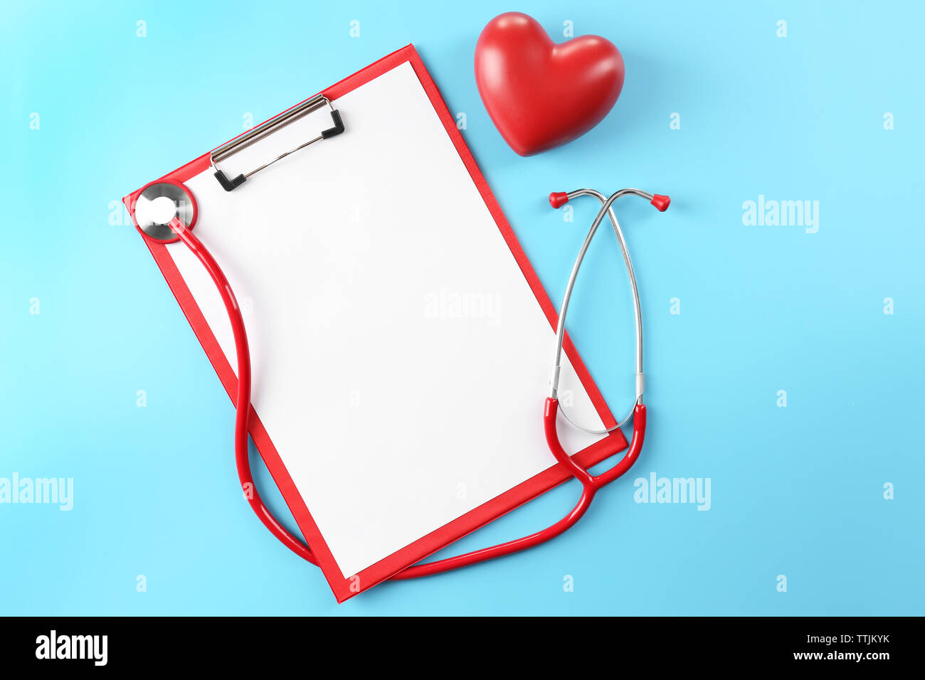 Red stethoscope with prescription on blue background Stock Photo - Alamy
