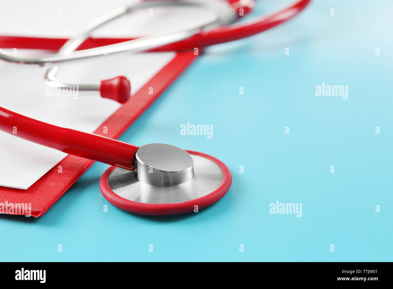 Red stethoscope with prescription on blue background Stock Photo - Alamy